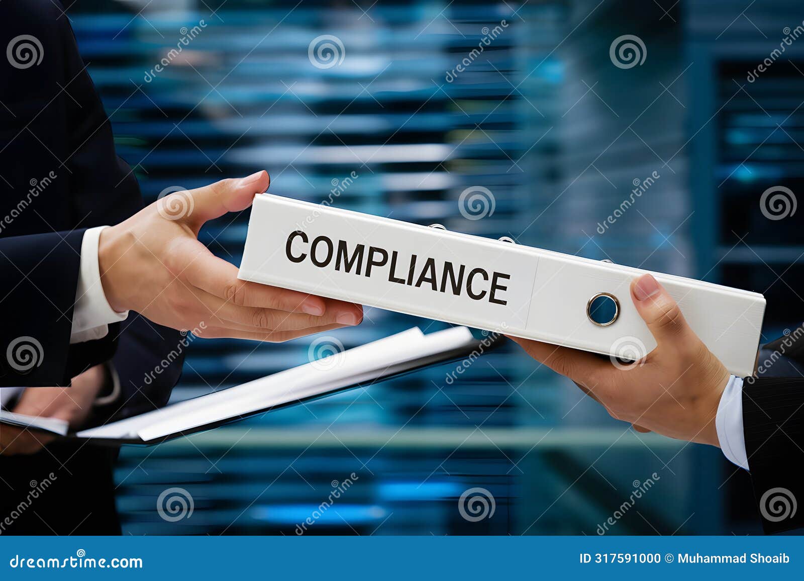 A Hand Passing Over a Compliance Binder in a Professional Exchange ...