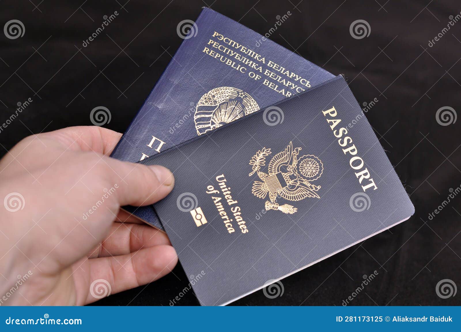 Hand with a Passport of a Citizen of the USA and Belarus. Double ...