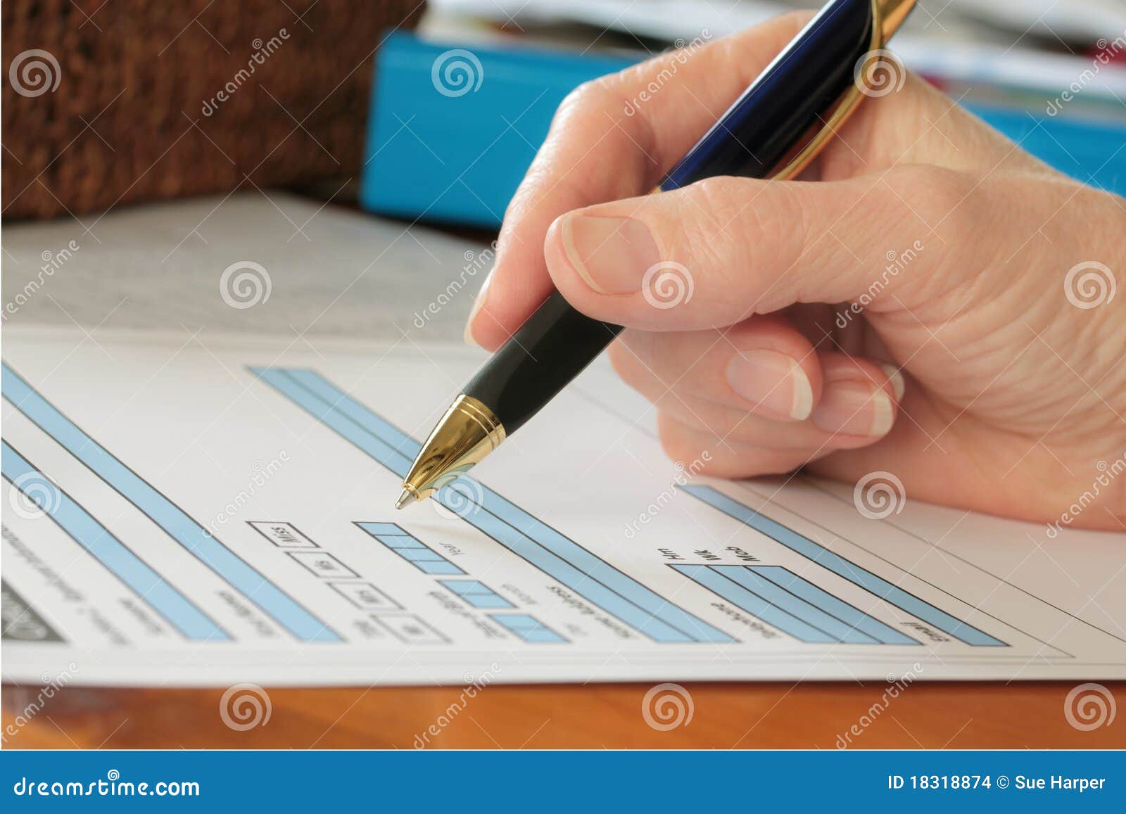 Hand with Pen Completing Blue Form Stock Photo - Image of folder ...