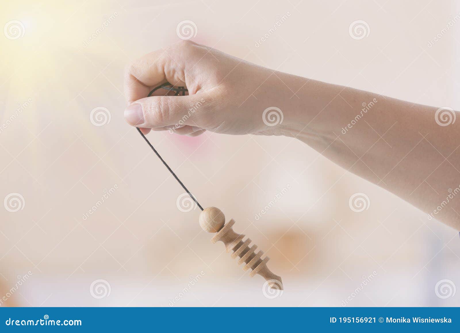Using big wooden pendulum stock image. Image of hand - 195156921