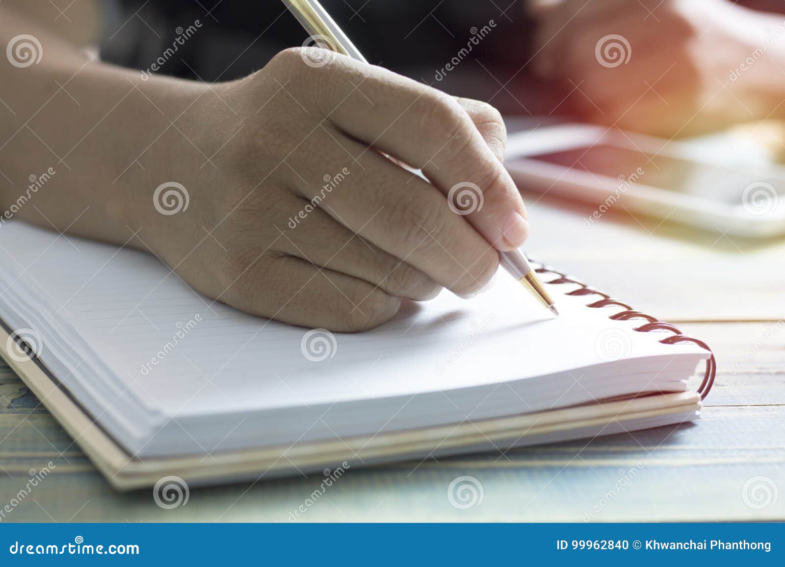 Hand of People, Student Writing and Note on Notebook on Wood Table with ...