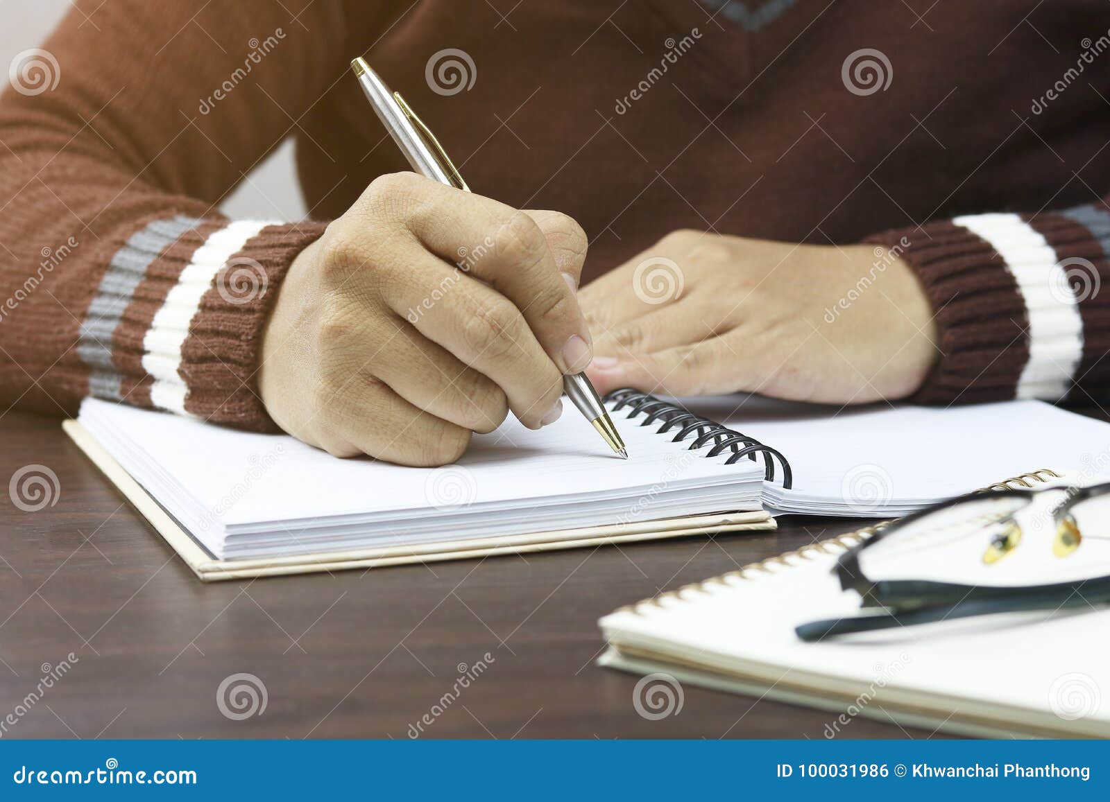 Hand of People, Student Writing and Note on Notebook on Wood Table with ...