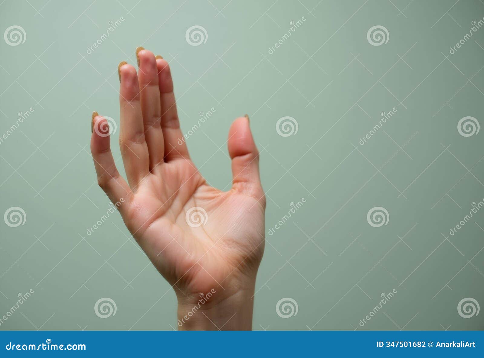 Hand Raised with Fingers Spread Against Green Background Stock ...
