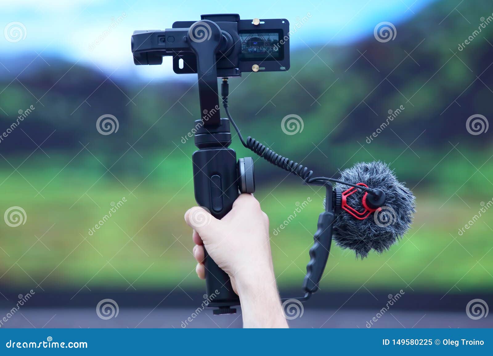 Hand of the Person Filming the Event on the Video Camera with a ...