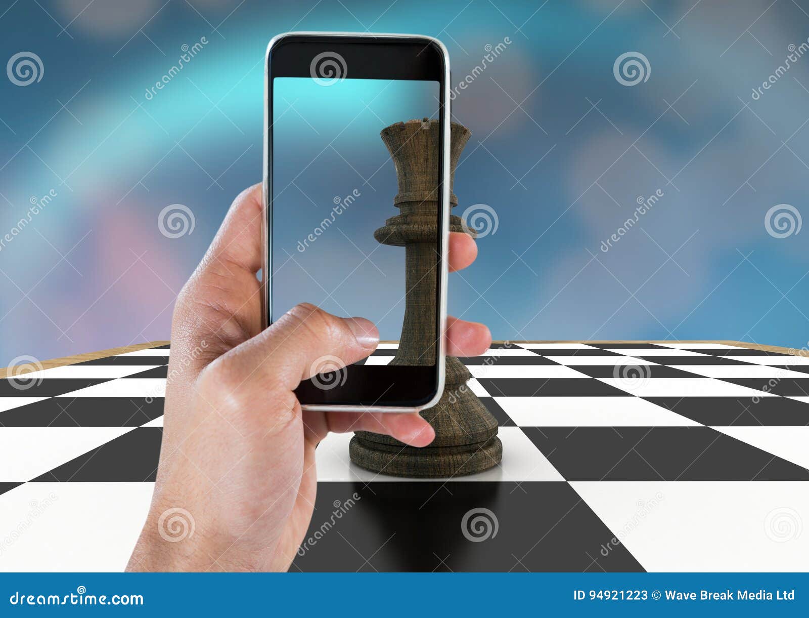 Hand with Phone Against Chess Piece and Blue Bokeh Stock Image - Image ...