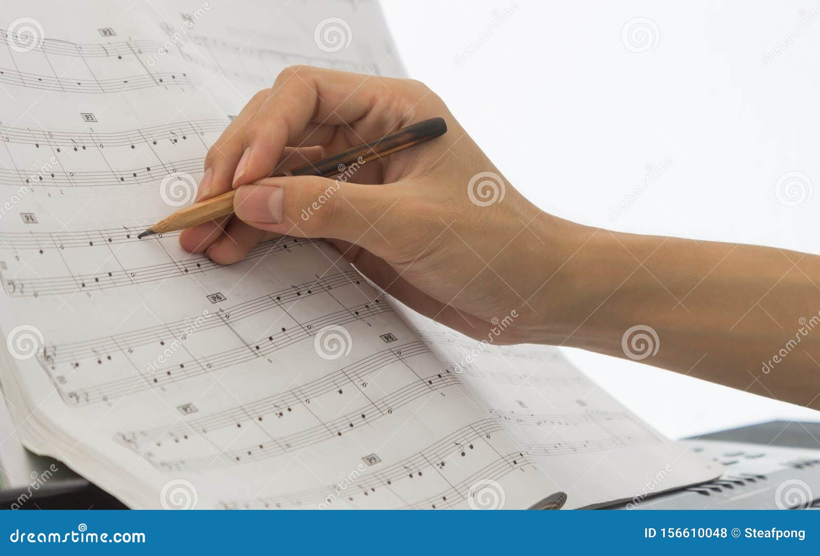 Hand of Piano Player is Writing Notes on Piano Staff or Sheet Music ...