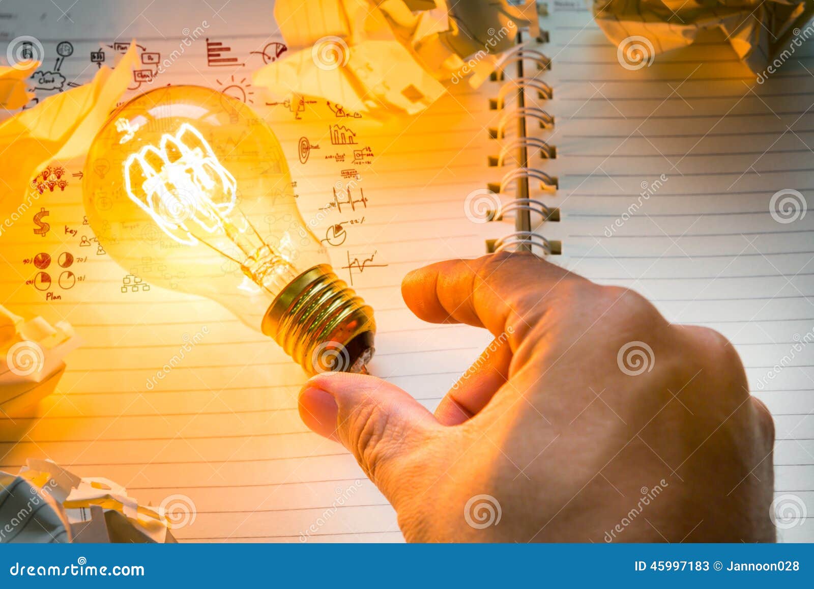 Hand Pick Light Bulb with Drawing Graph Over Note Book Stock Image ...