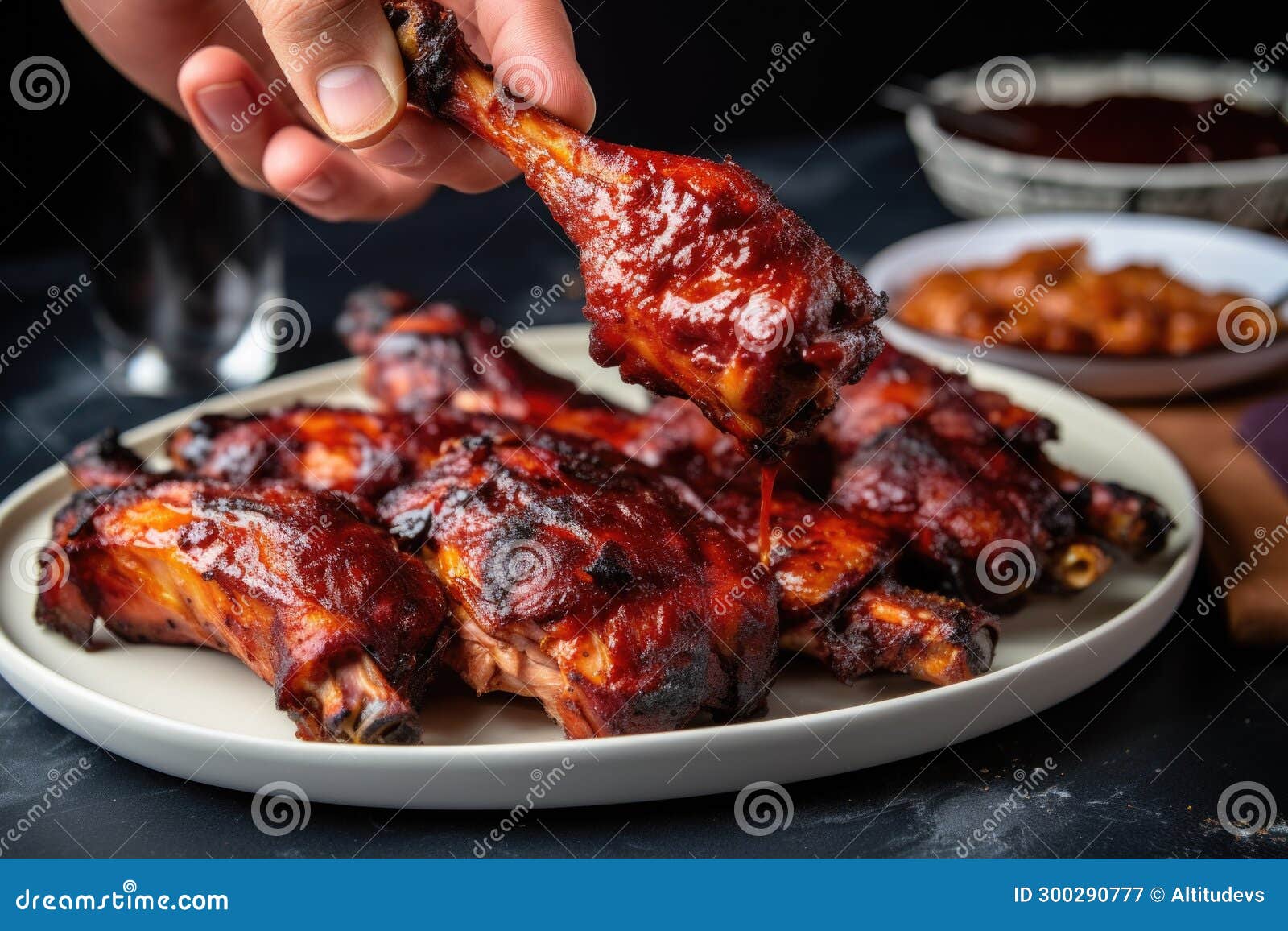 Hand Picking a Bbq Chicken Drumstick from a Serving Plate Stock Image ...