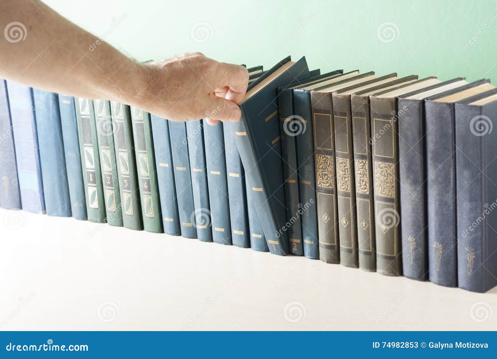 Hand Picking Book from the Shelf in Library Stock Image - Image of ...