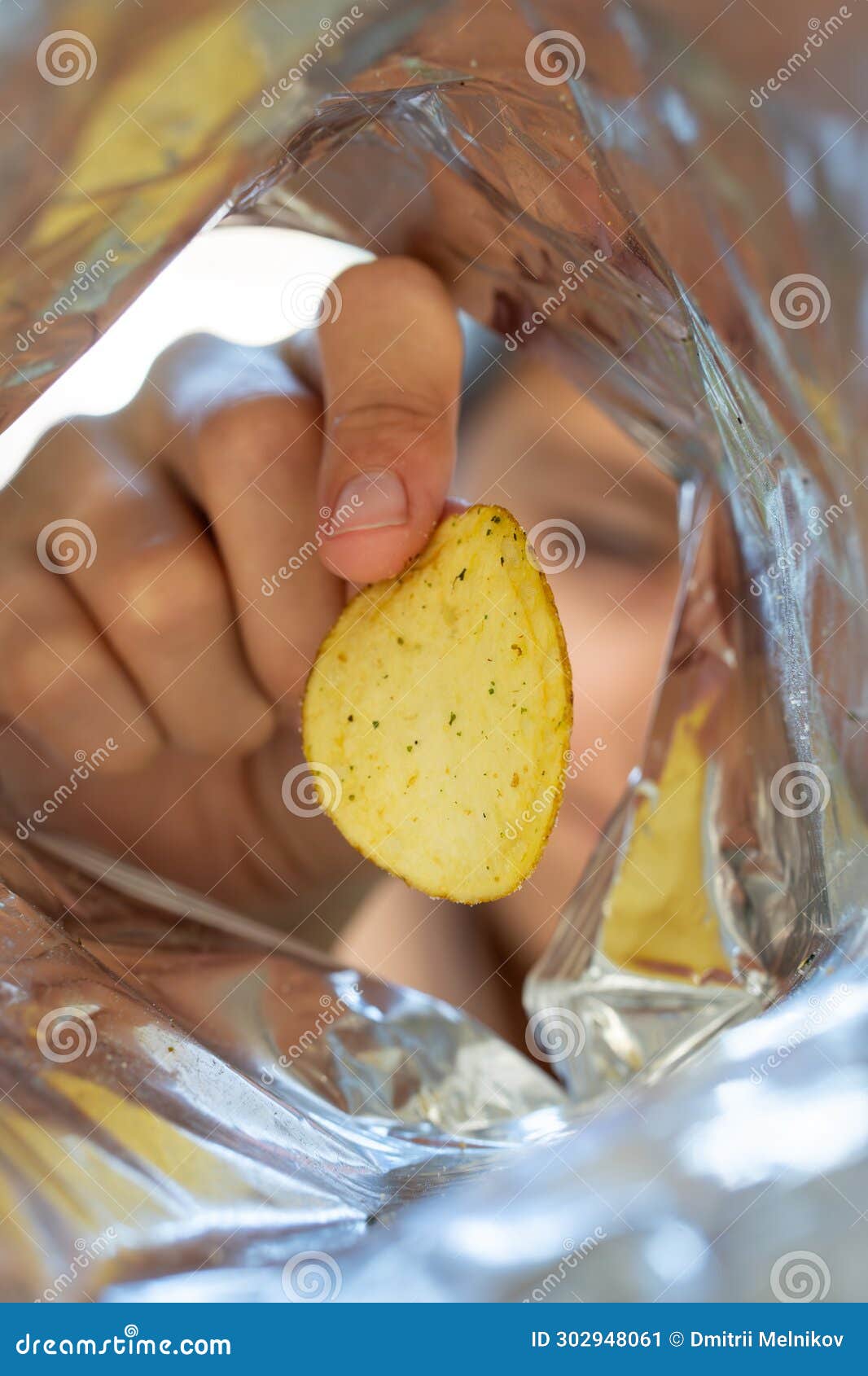 Hand Picking Potato Chips Inside Snack Bag. Open Pack of Chips. Stock ...
