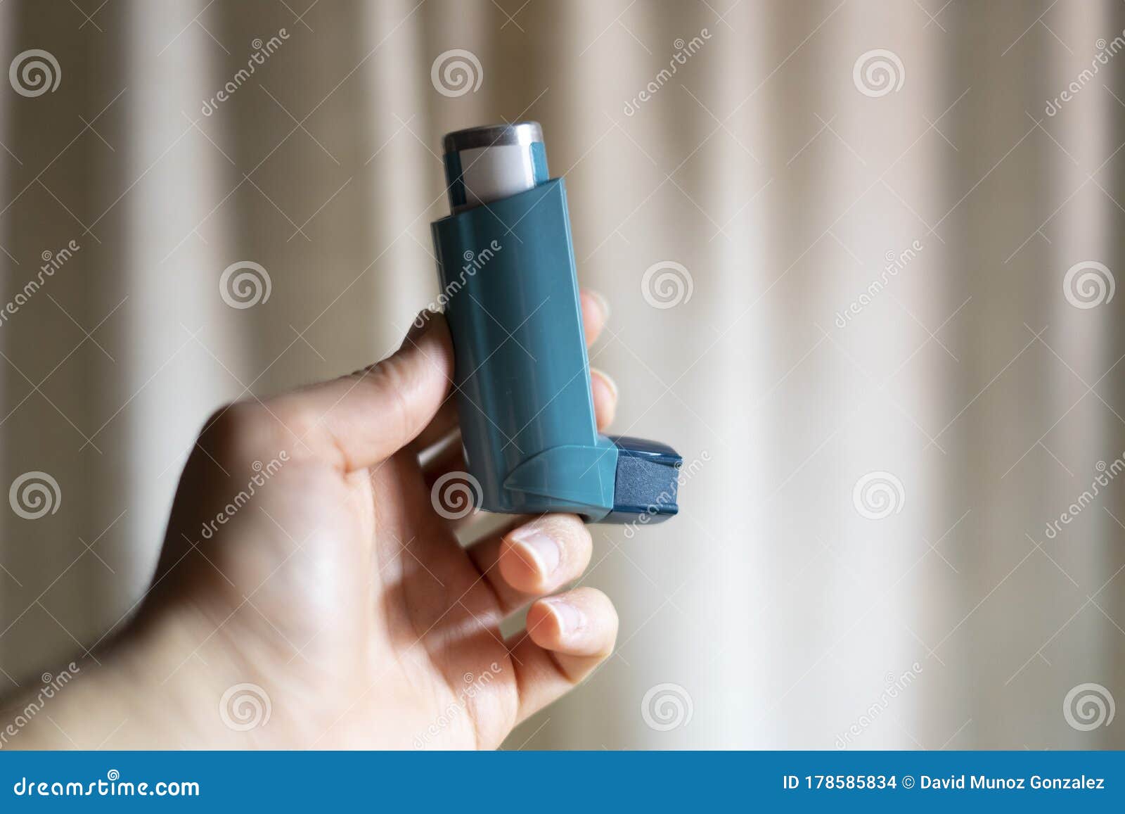 Hand Picking Up a Blue Asthma Inhaler Stock Photo - Image of inhaler ...