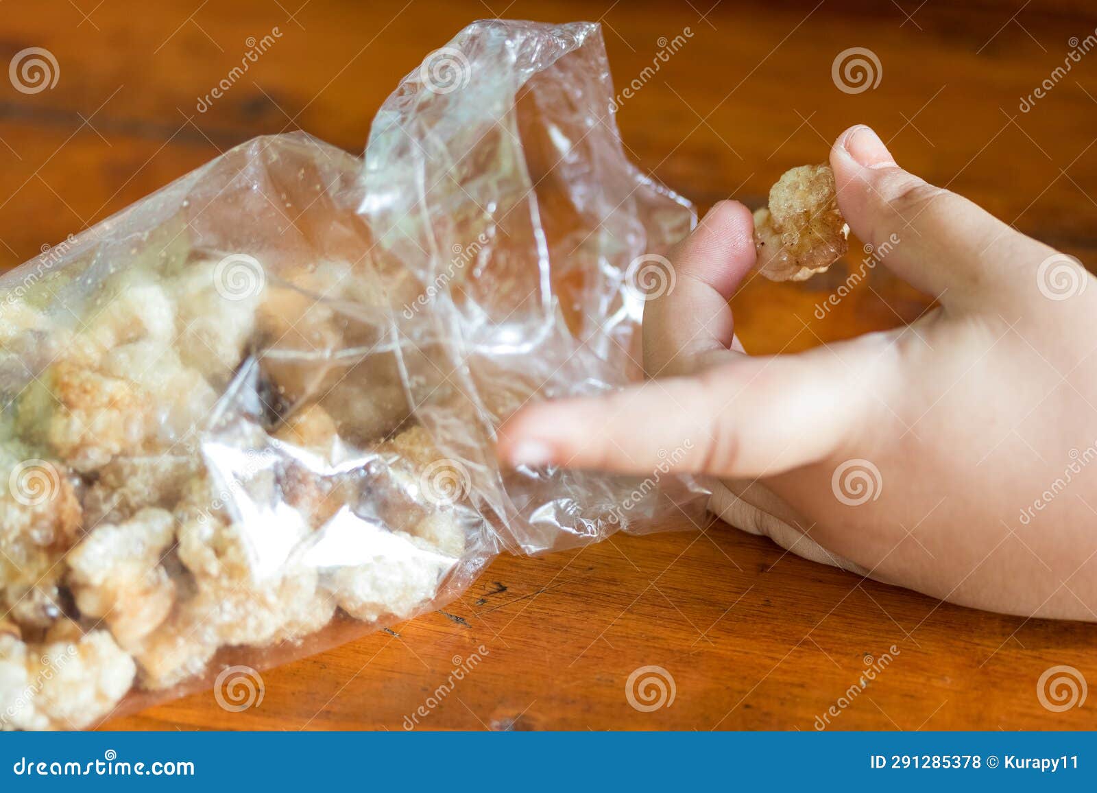 Hand is Picking Up Pork Snacks in Bag on Table Stock Photo - Image of ...