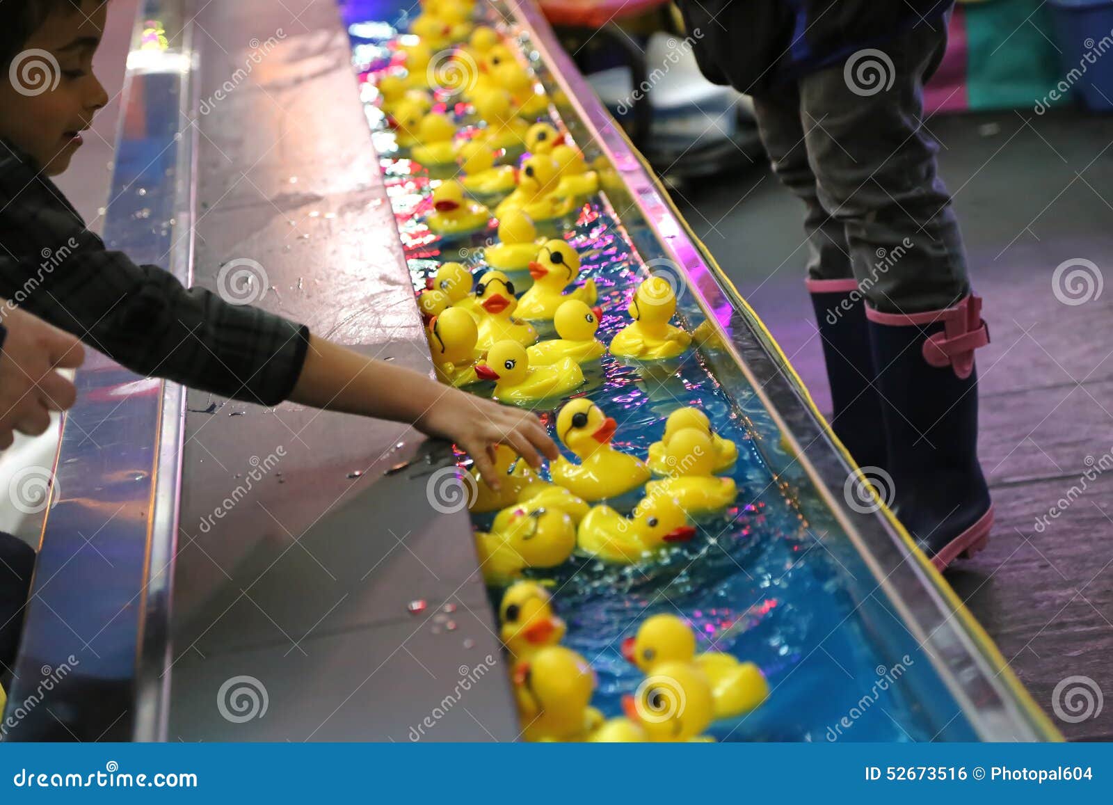 Hand picking yellow duck editorial photo. Image of cute - 52673516