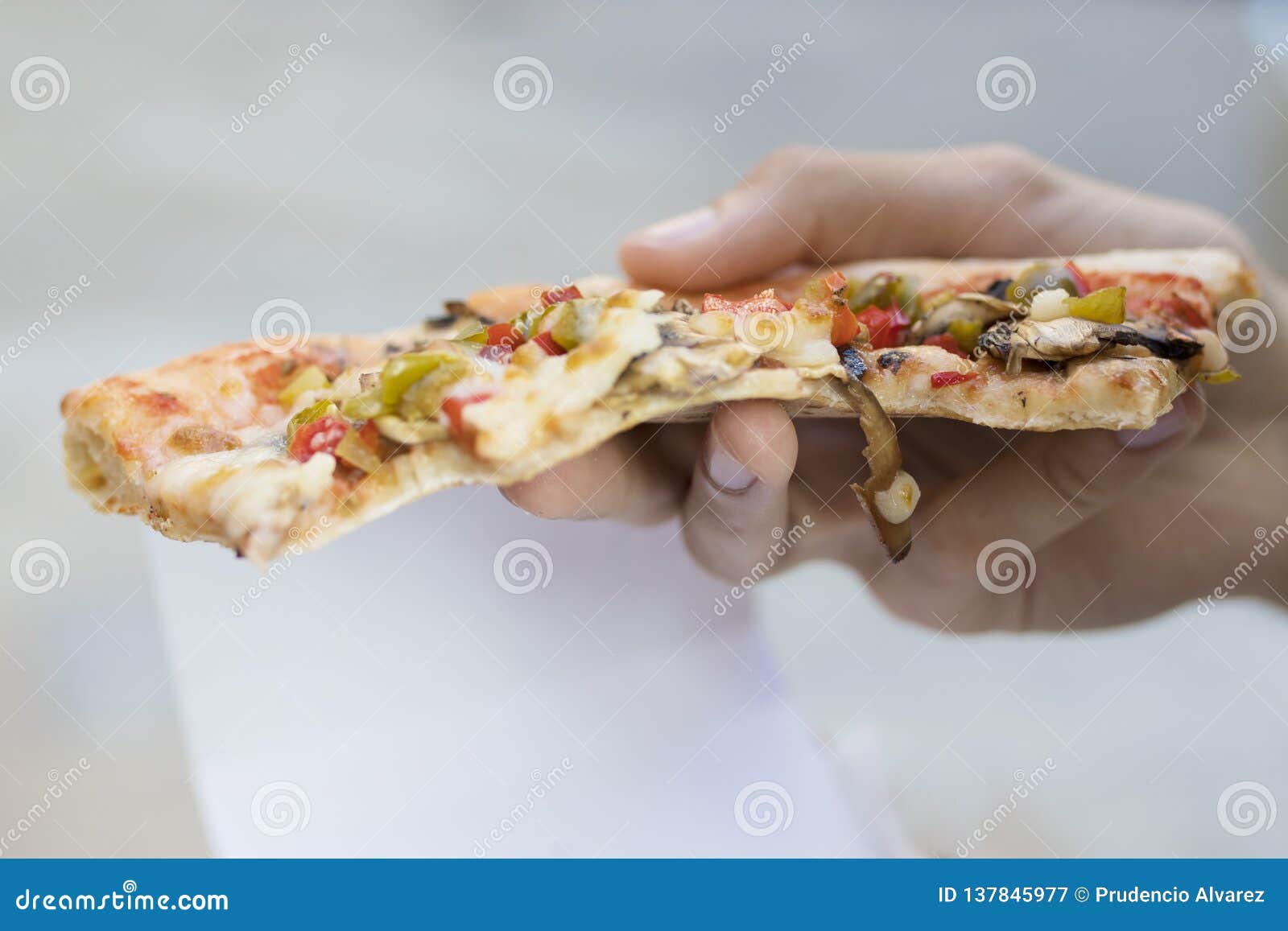 Hand with pizza portion stock image. Image of italy - 137845977