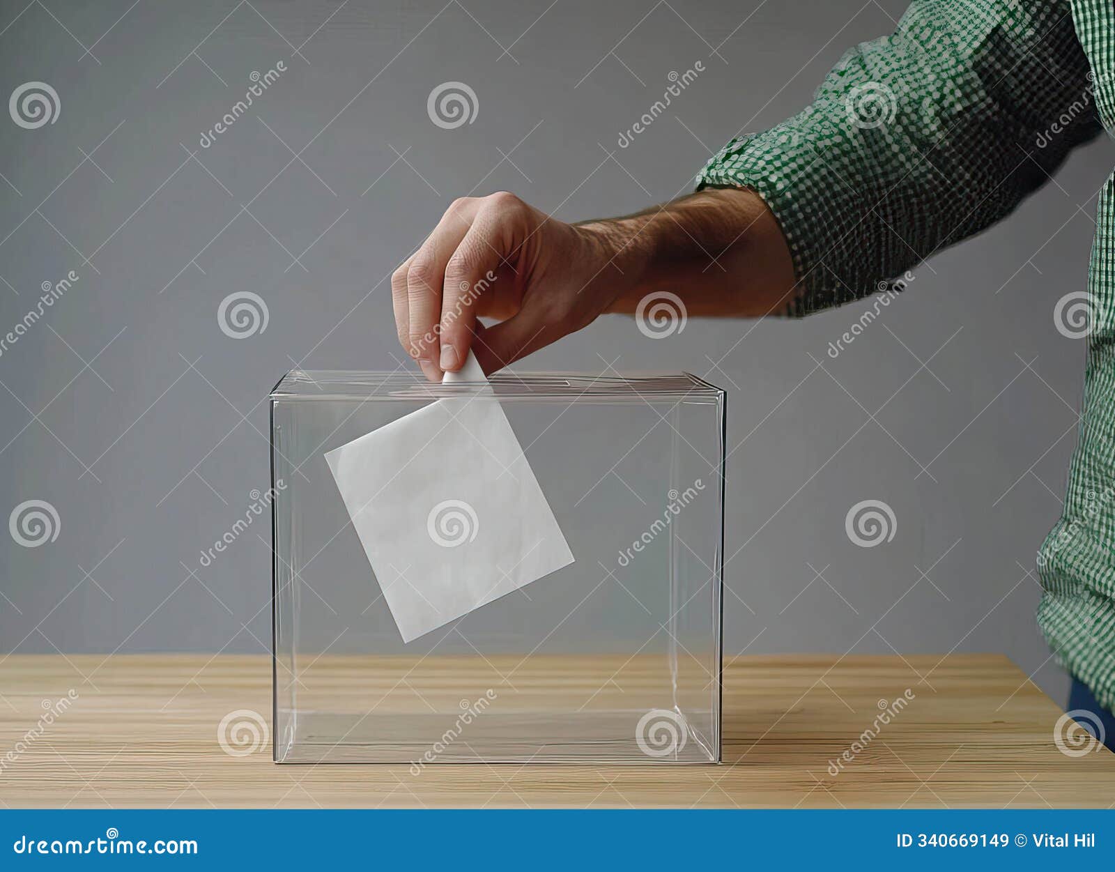 A Person Casting a Ballot into a Transparent Ballot Box on a Wooden ...