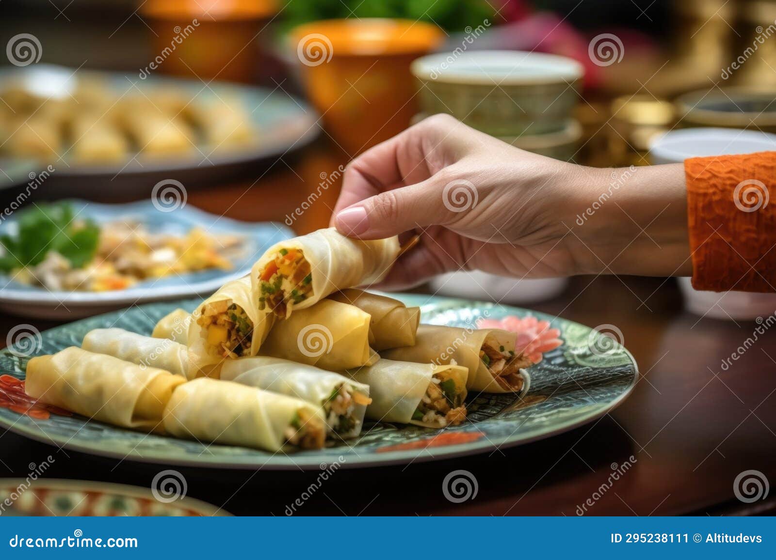 Hand Placing a Bite-sized Spring Roll Onto a Guests Plate Stock Image ...