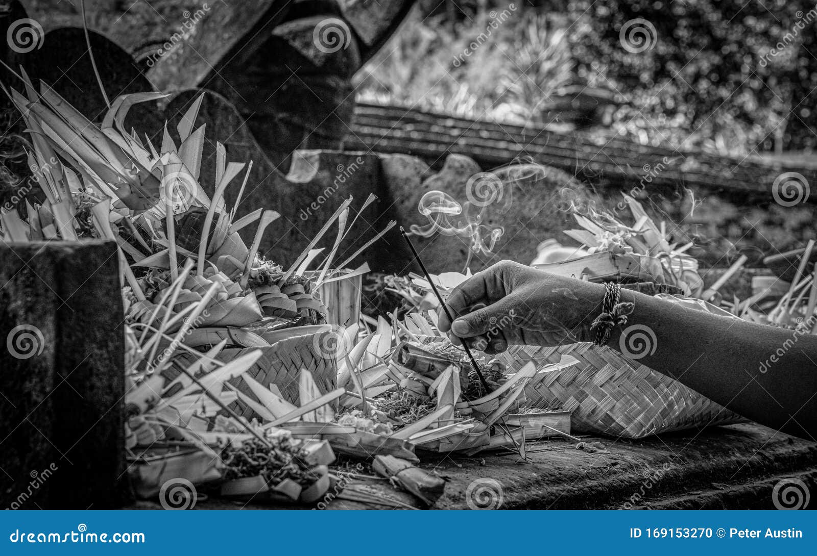 A Hand Placing Burning Incense in an Offering at a Balinese Temple ...