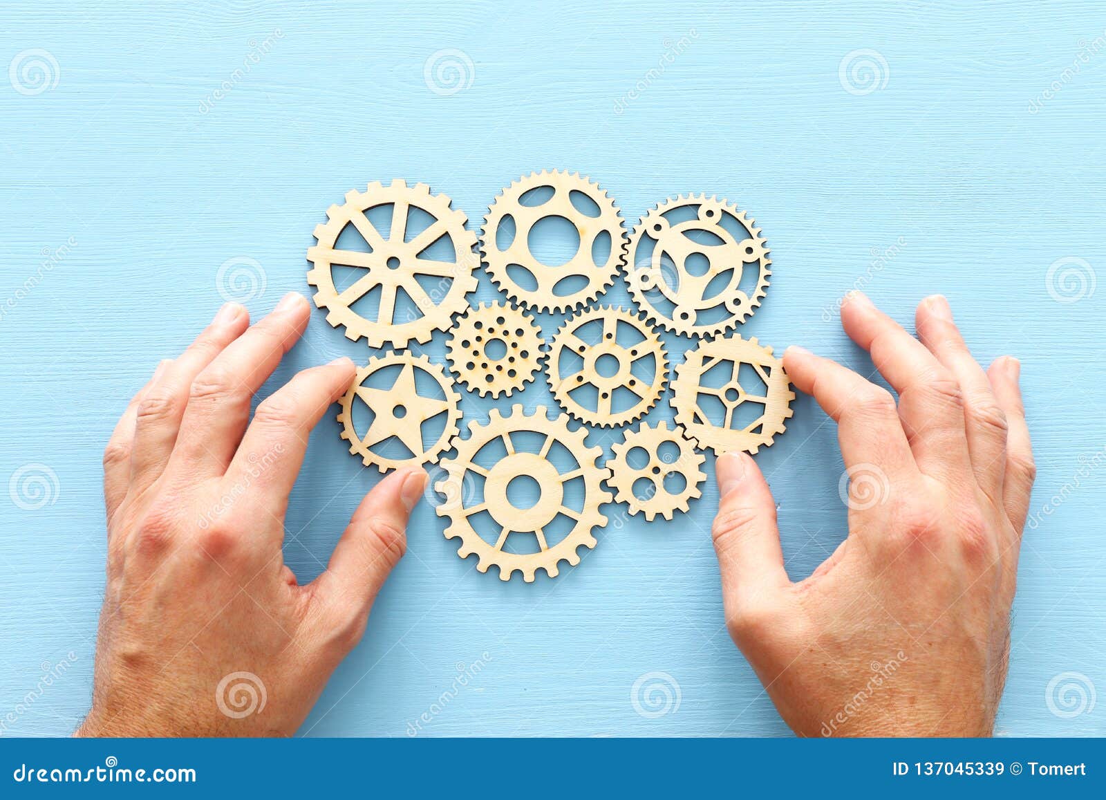 Hand Placing a Cogwheel in Set of Gears Mechanism. Stock Image - Image ...