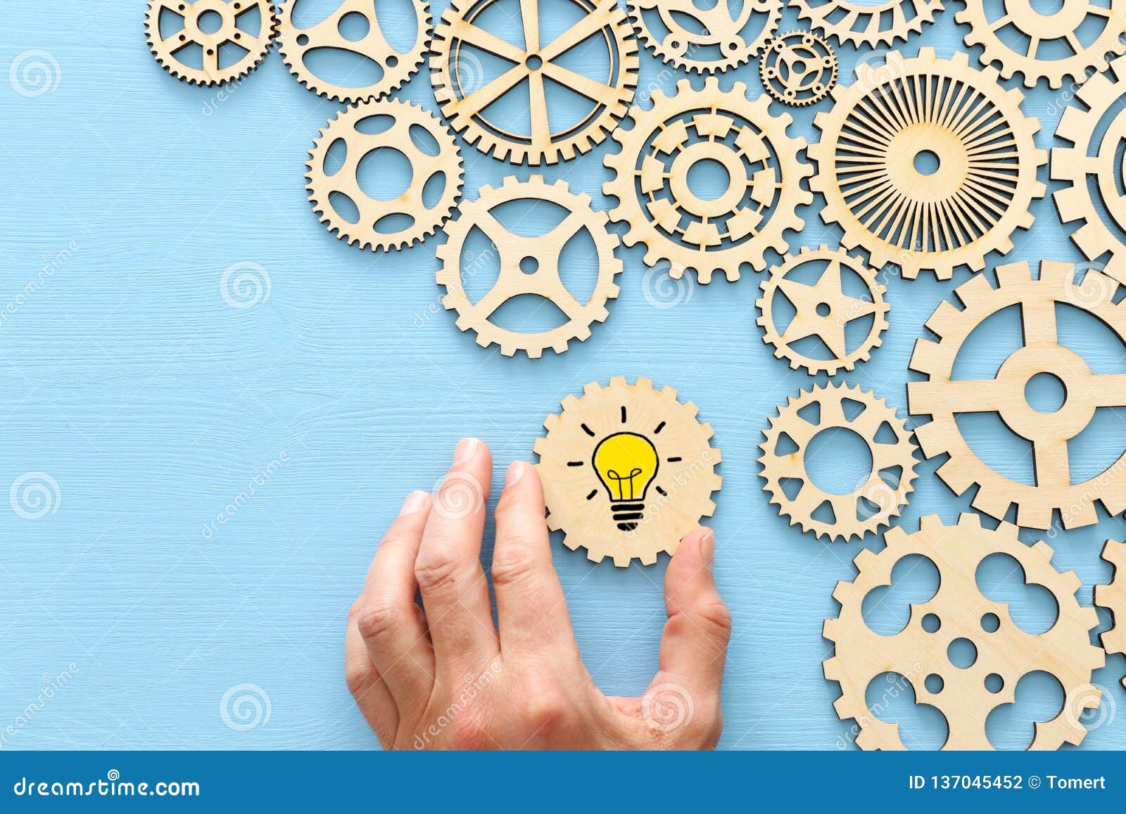 Hand Placing a Cogwheel in Set of Gears Mechanism. Stock Photo - Image ...