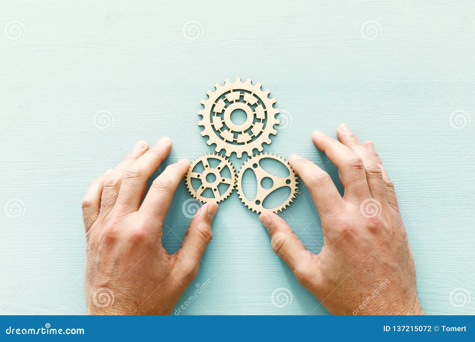 Hand Placing a Cogwheel in Set of Gears Mechanism. Stock Photo - Image ...