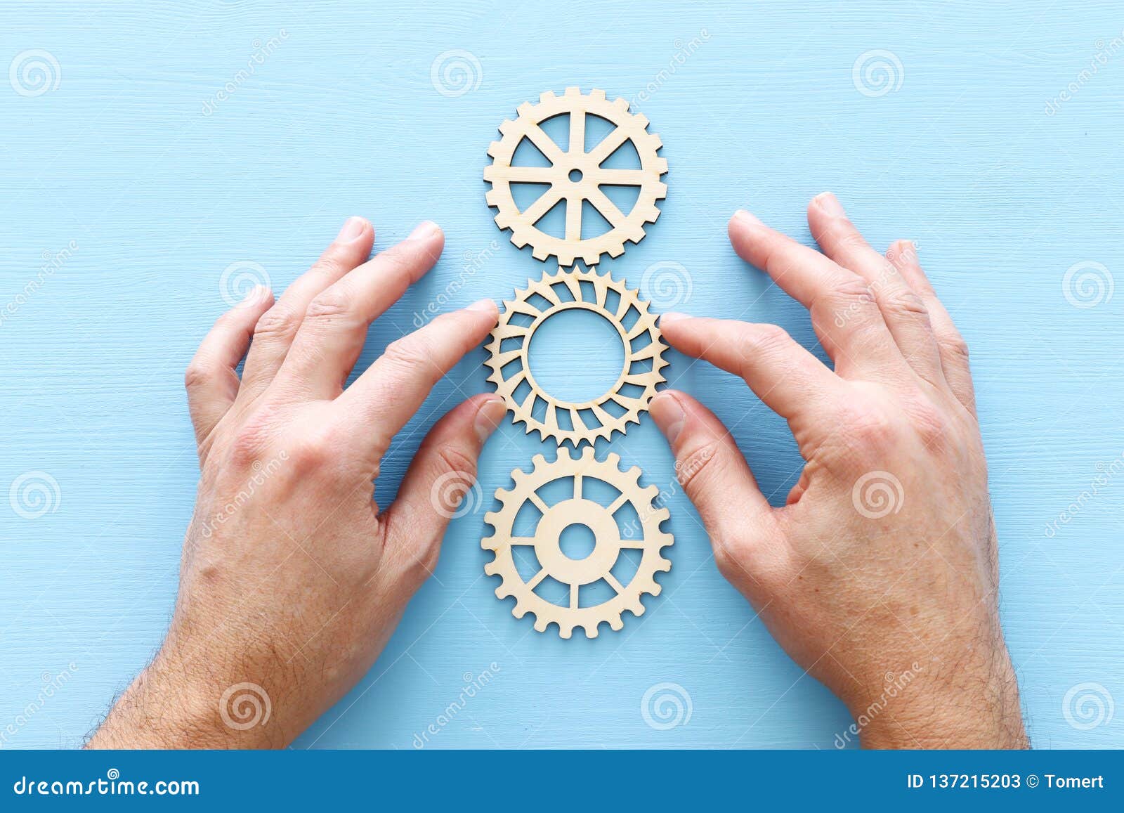 Hand Placing a Cogwheel in Set of Gears Mechanism. Stock Image - Image ...