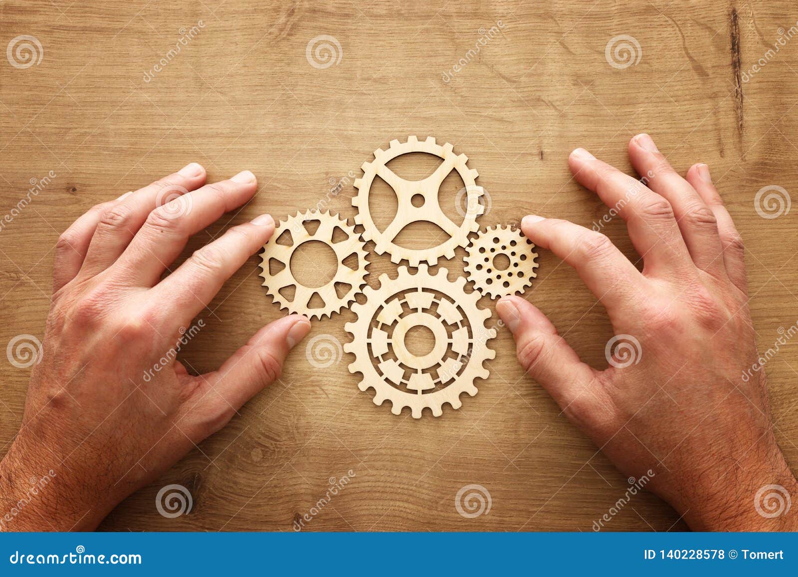Hand Placing a Cogwheel in Set of Gears Mechanism. Stock Photo - Image ...