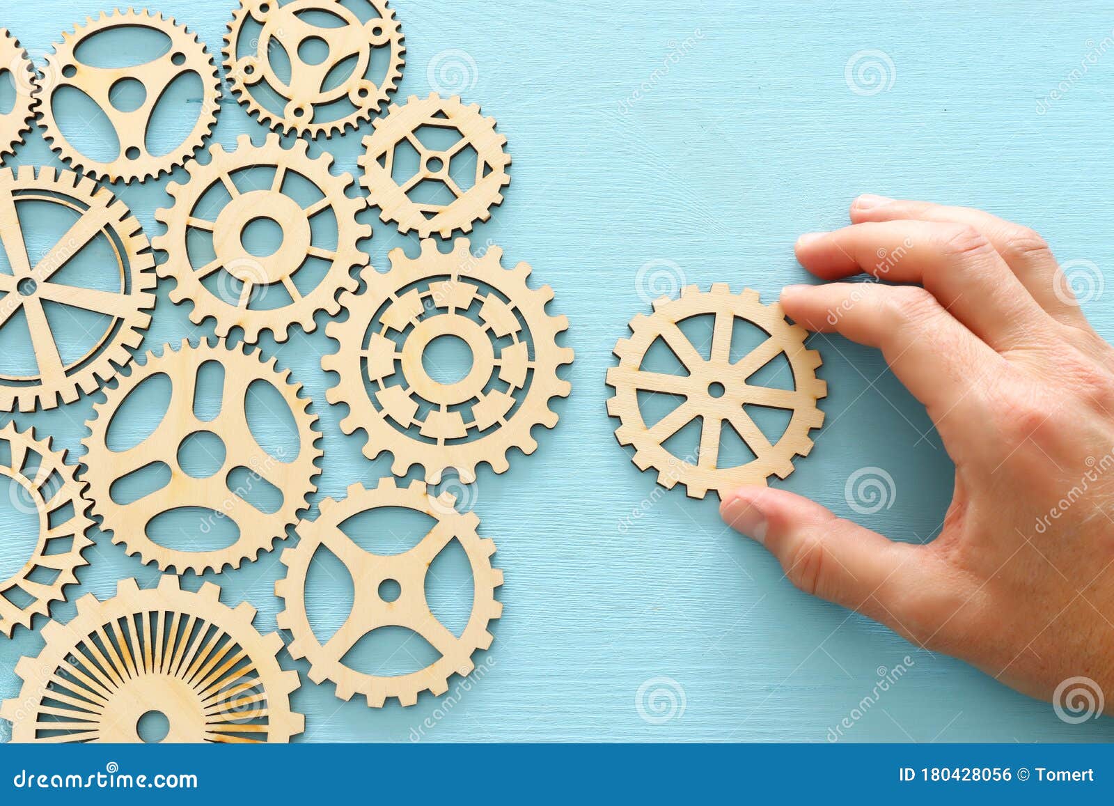 Hand Placing a Cogwheel in Set of Gears Mechanism Stock Photo - Image ...