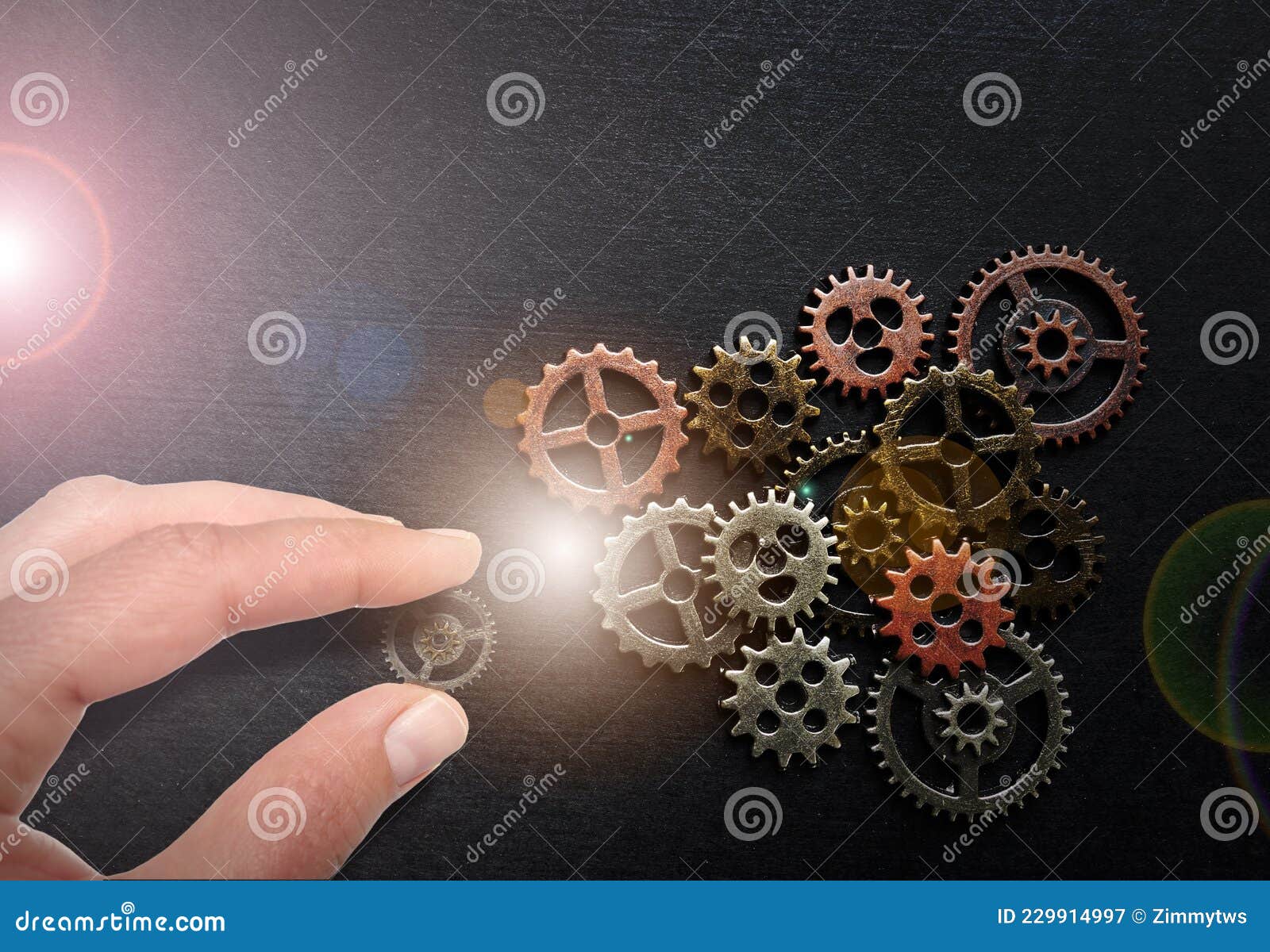 Hand Placing a Gear into Other Assorted Metal Gears To Complete a ...