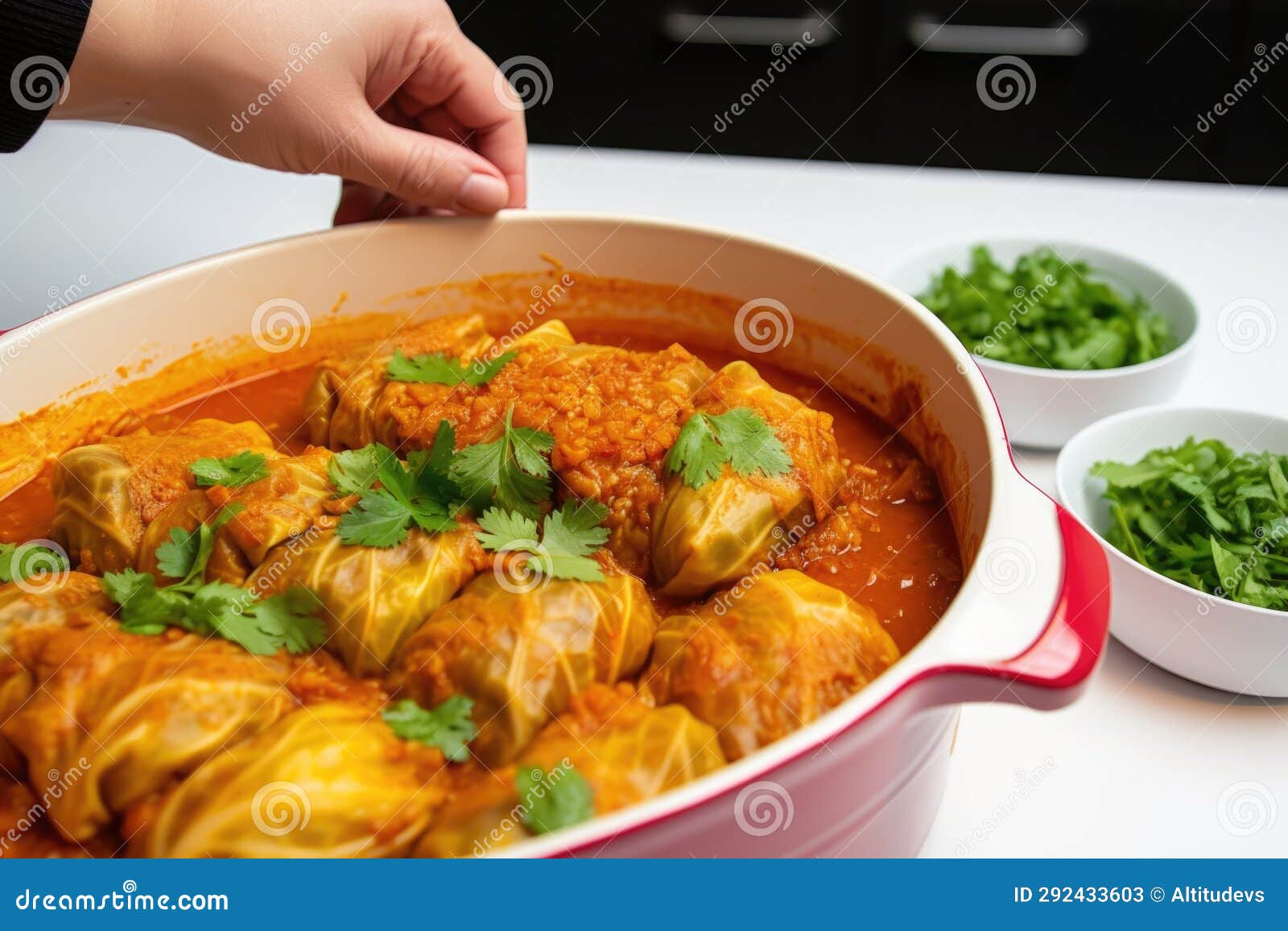 Hand Placing a Pile of Cabbage Rolls Onto a Serving Dish Stock Image ...