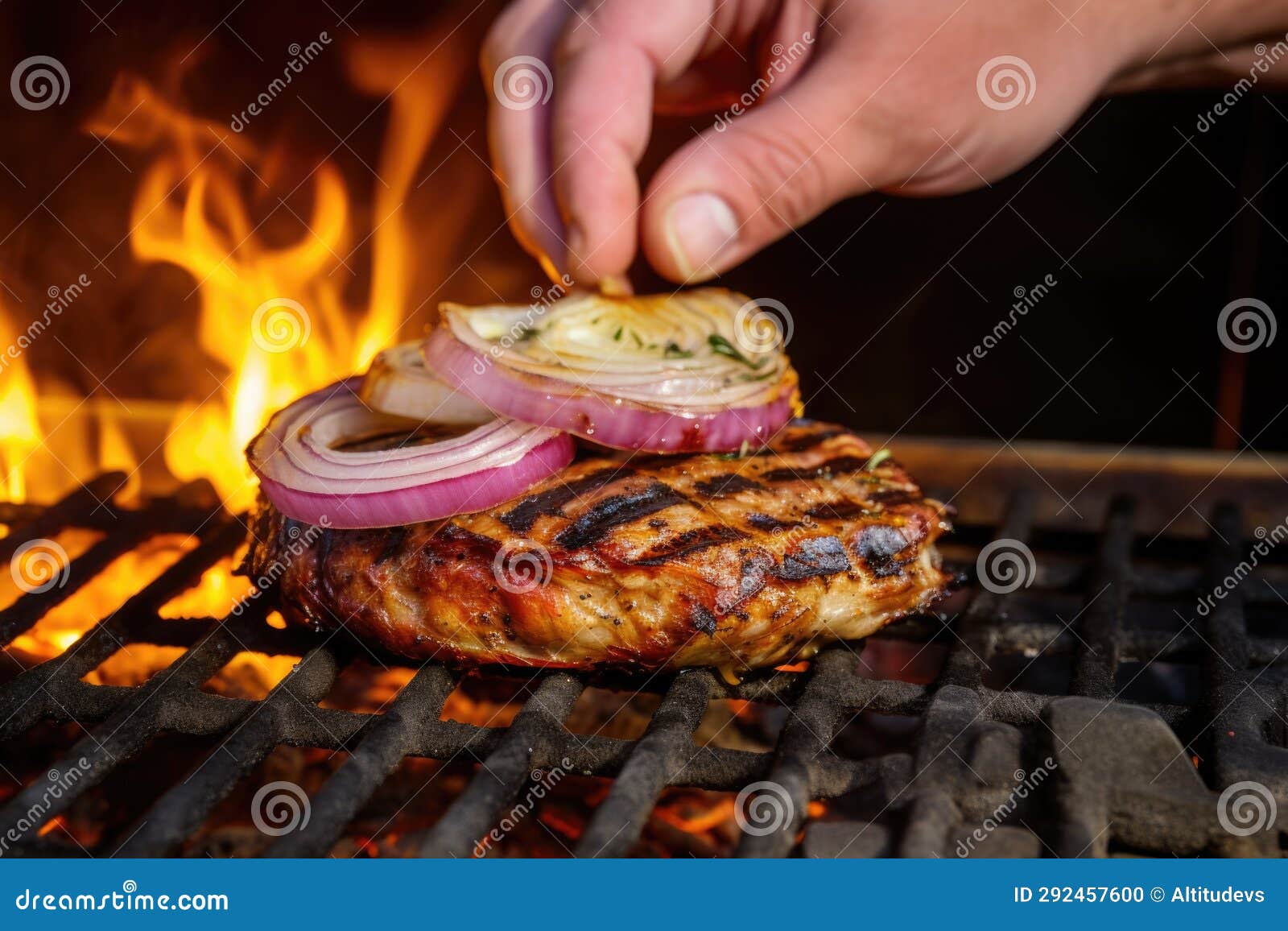 Hand Placing Thick Slice of Onion Onto Flame Grilled Burger Stock ...