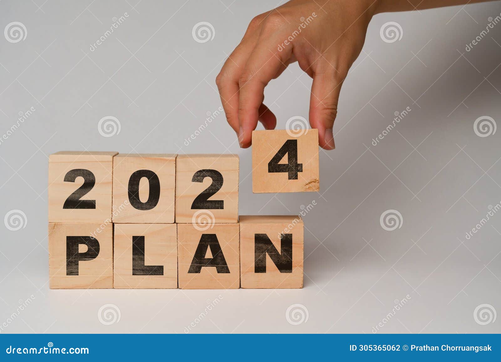 Hand Placing Wooden Cube Blocks with 2024 PLAN Text on White Background ...