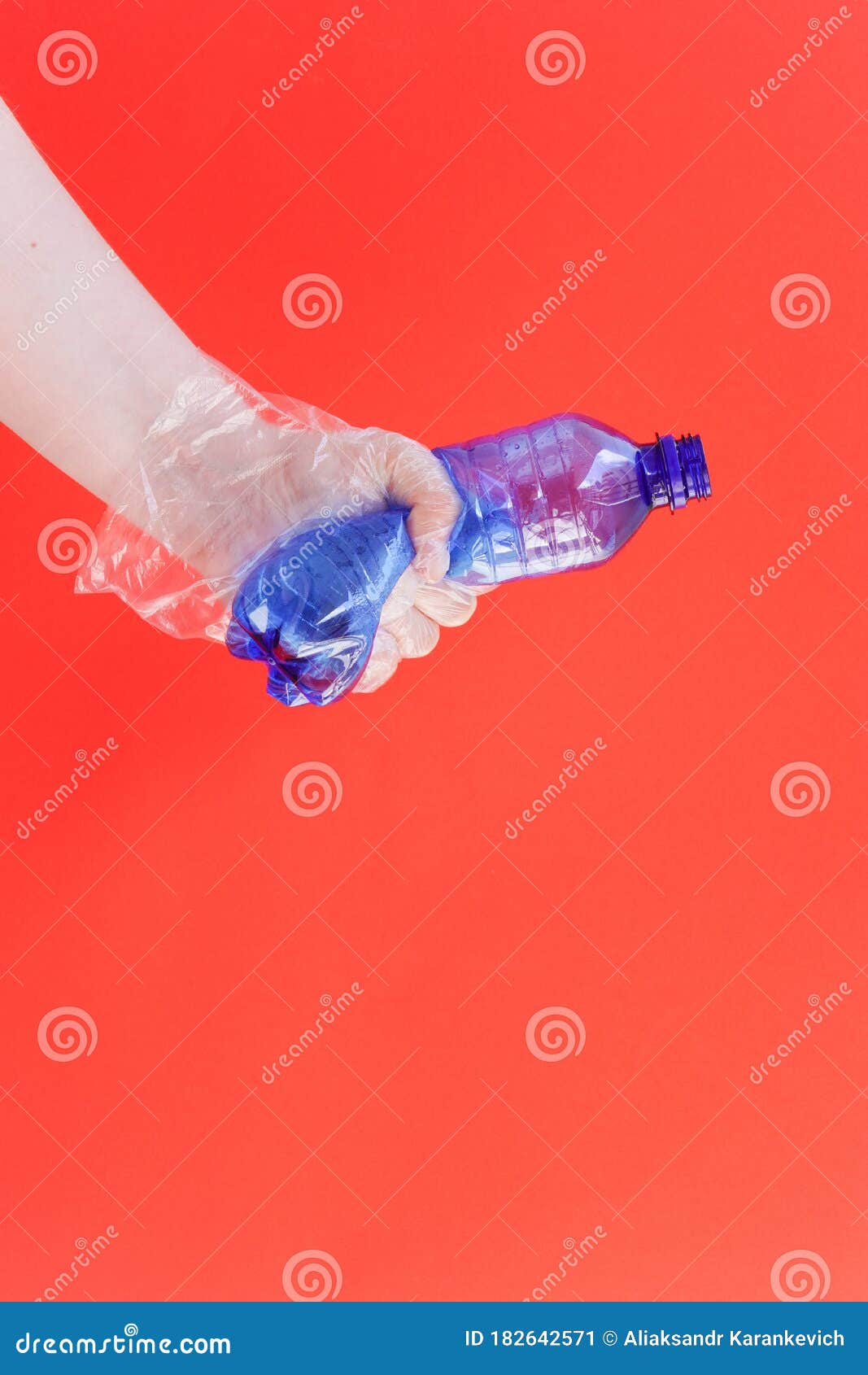 Hand in Plastic or Rubber Disposable Glove Holds Plastic Blue Bottle of ...