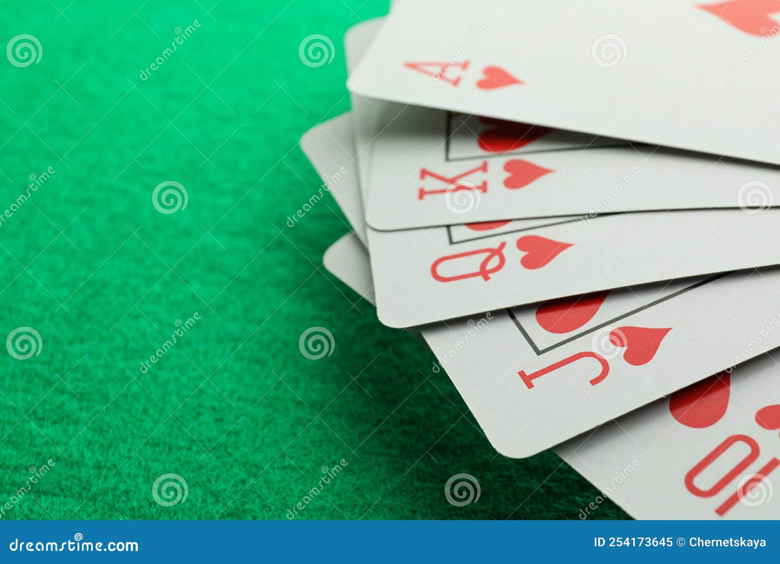 Hand of Playing Cards on Green Table, Closeup. Space for Text Stock ...