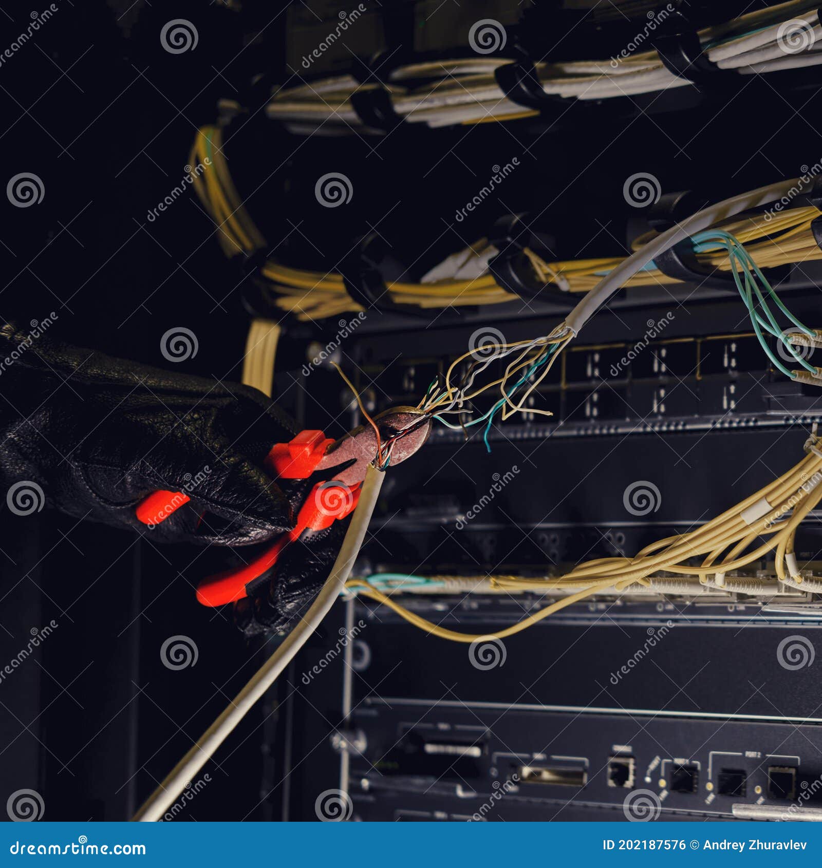 Hand with Pliers Bites the Wires in the Server Room. Concept of ...