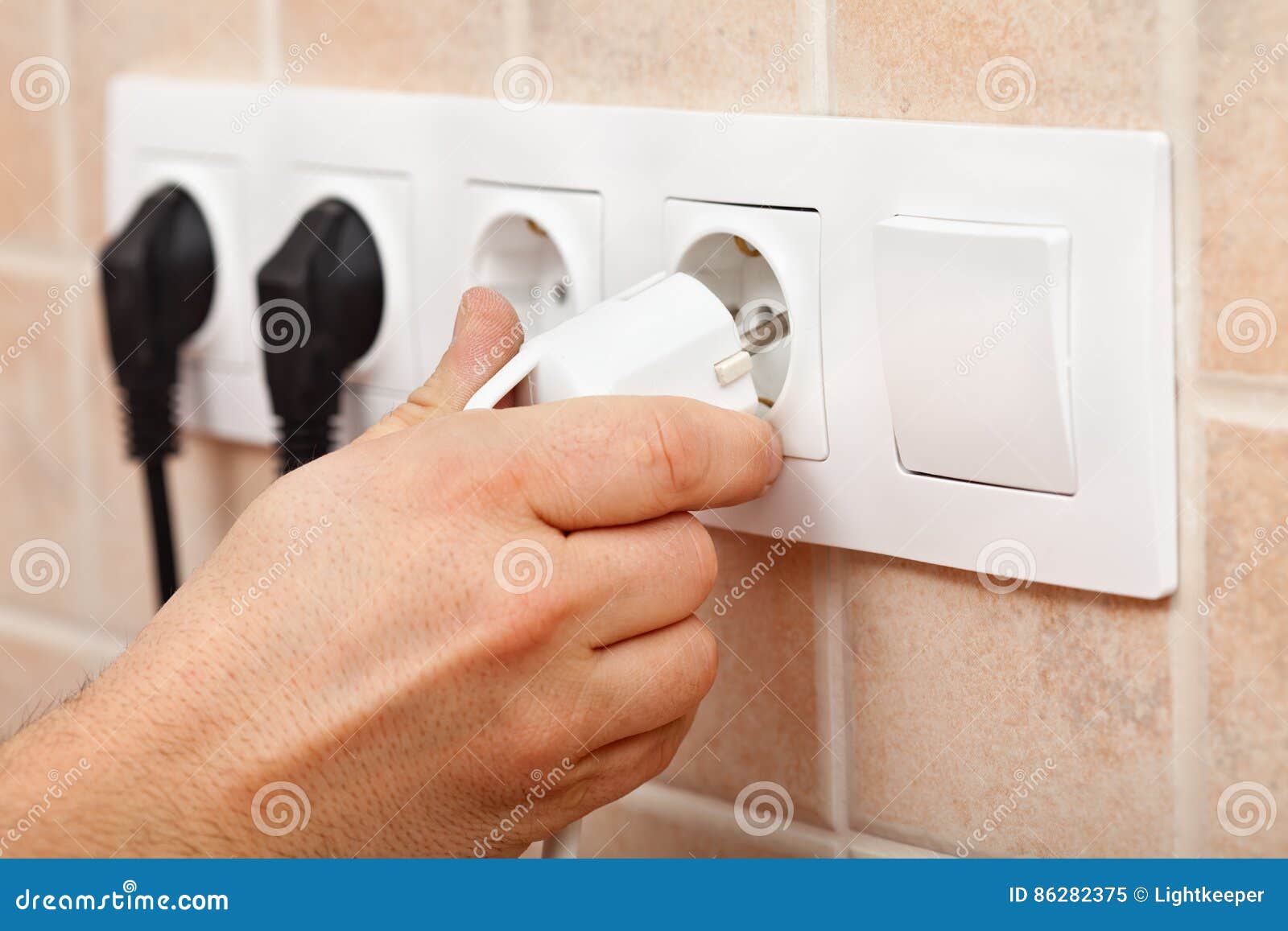 Hand Plugging a Power Cord into Electrical Wall Fixture Stock Image ...