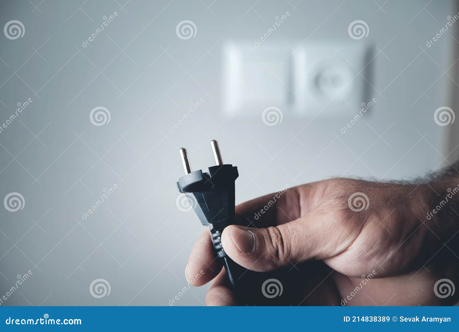 Hand plugging power cord stock image. Image of closeup - 214838389