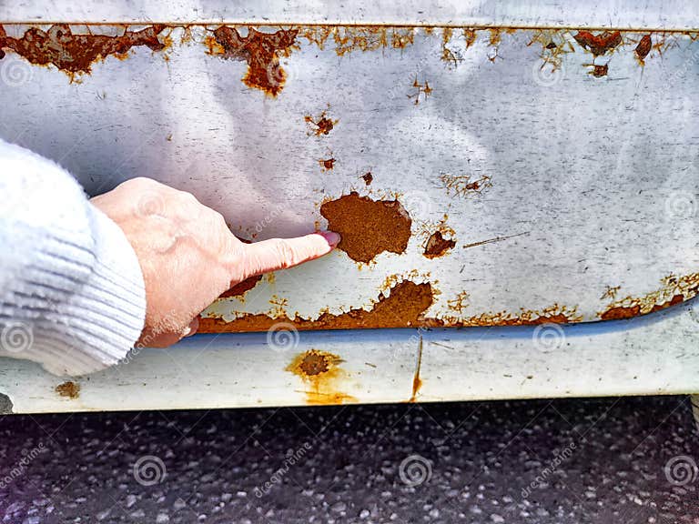 A Hand Points at Rust Damage on a Cars Body Panel Stock Photo - Image ...