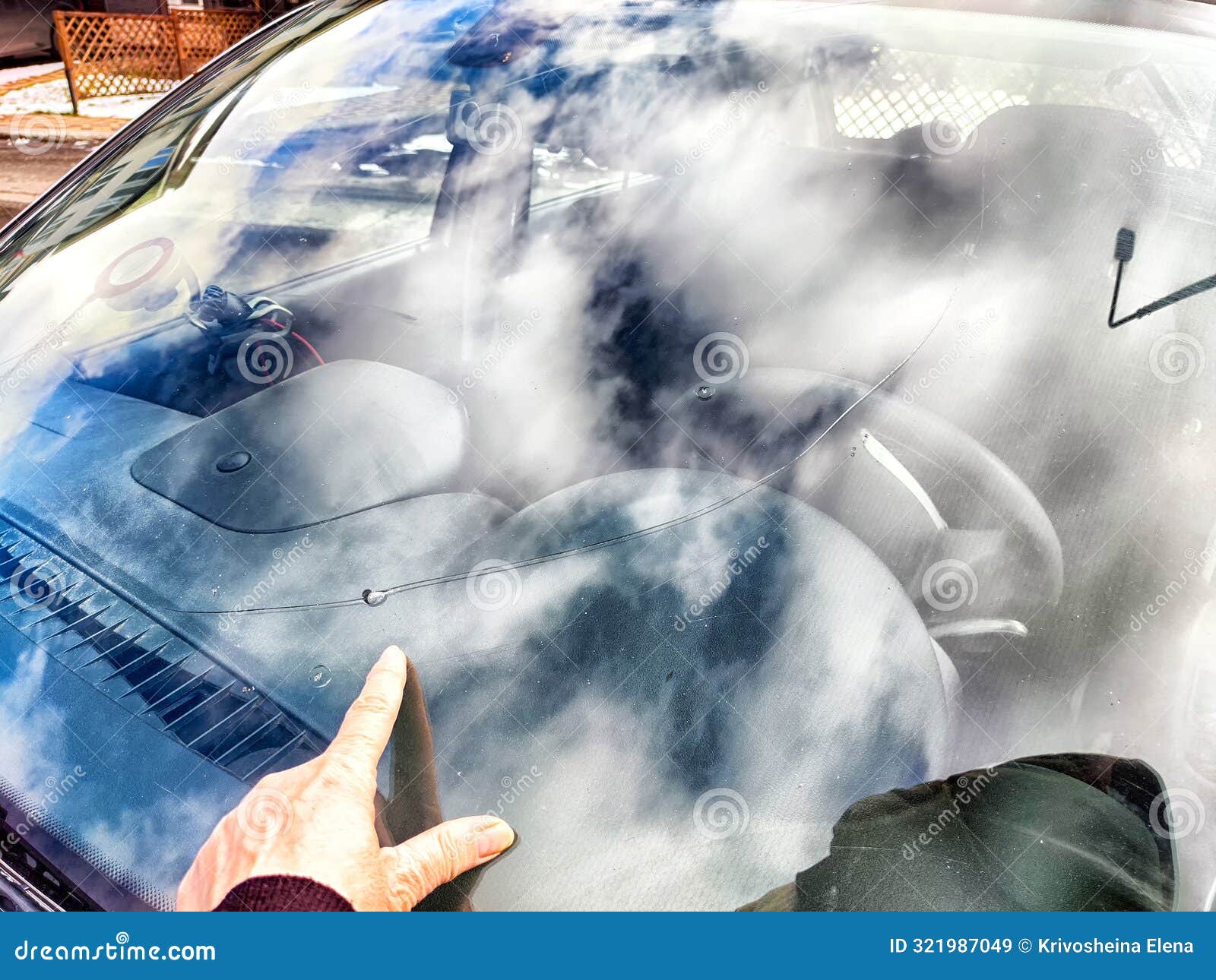 A Hand Points at a Small Chip and Crack on a Car Windshield Stock Image ...