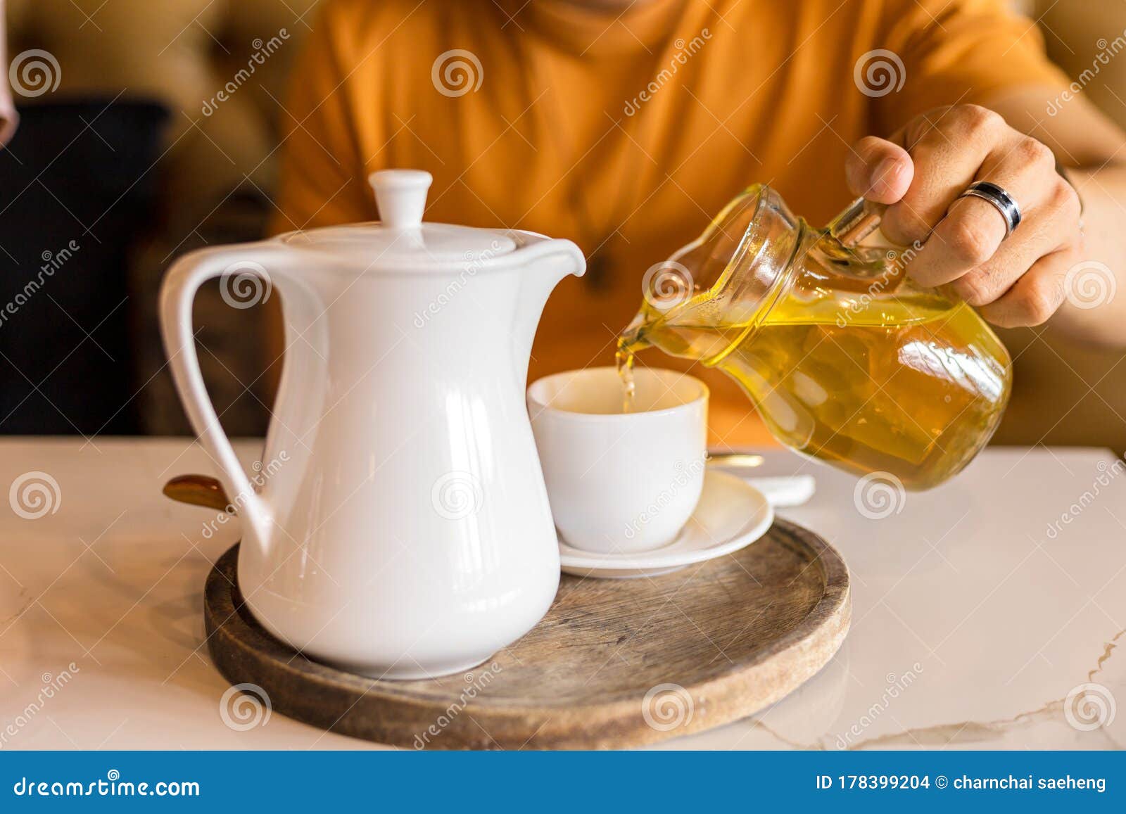 Hand Pour Tea in To Cup of Tea on the Table Stock Photo - Image of ...
