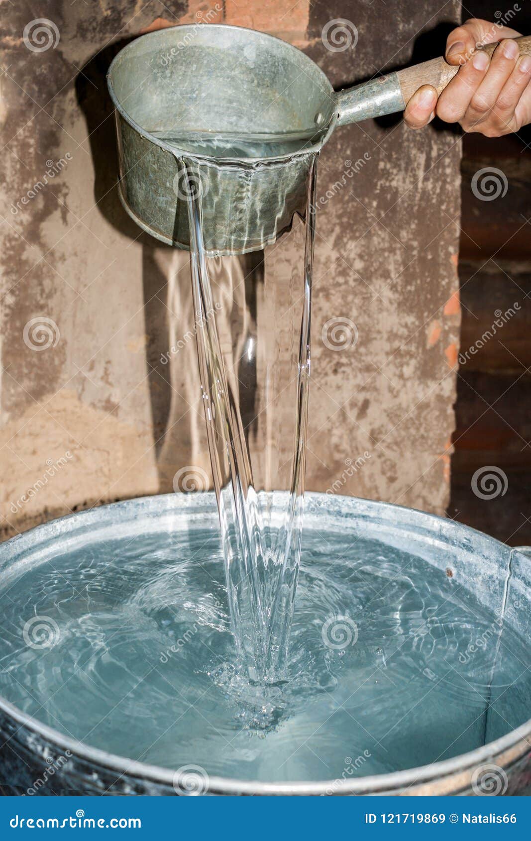 Hand Pour Water From Bucket Into The Metal Pot In Rural Bathhouse ... Hand Pour Water From Bucket Into The Metal Pot In Rural Bathhouse ...