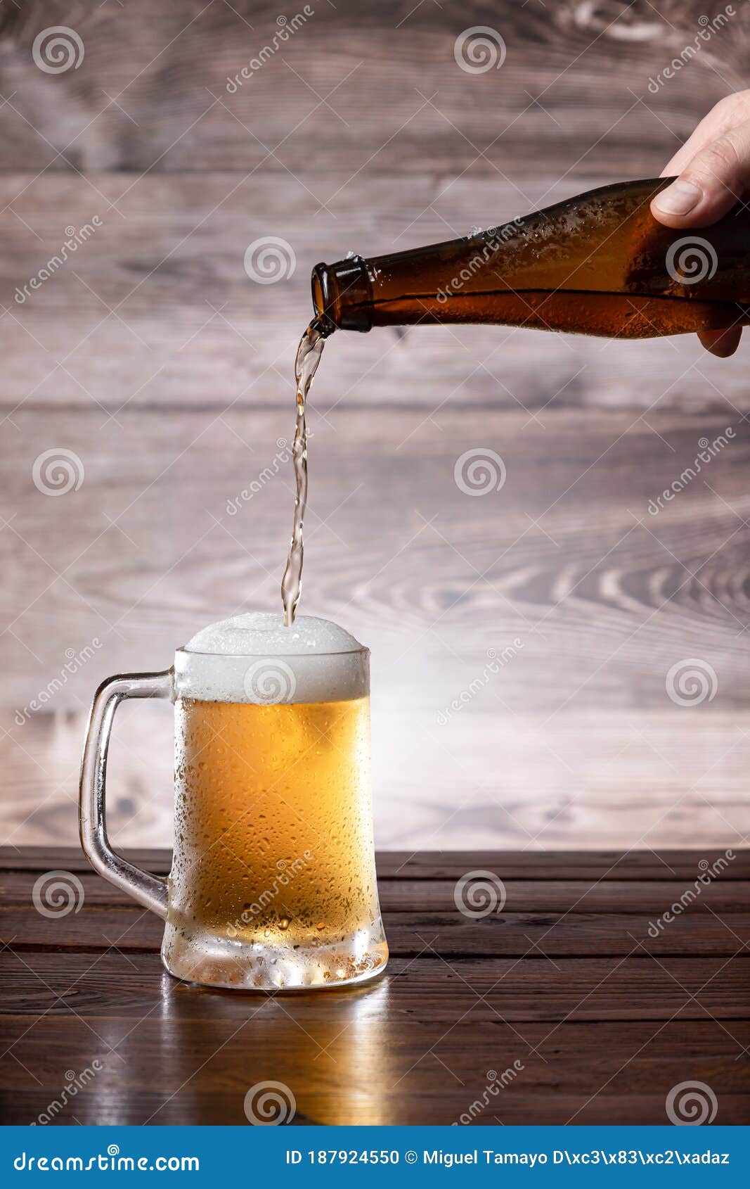 Hand Pouring Beer into a Cold Jug on Wooden Base Stock Photo - Image of ...
