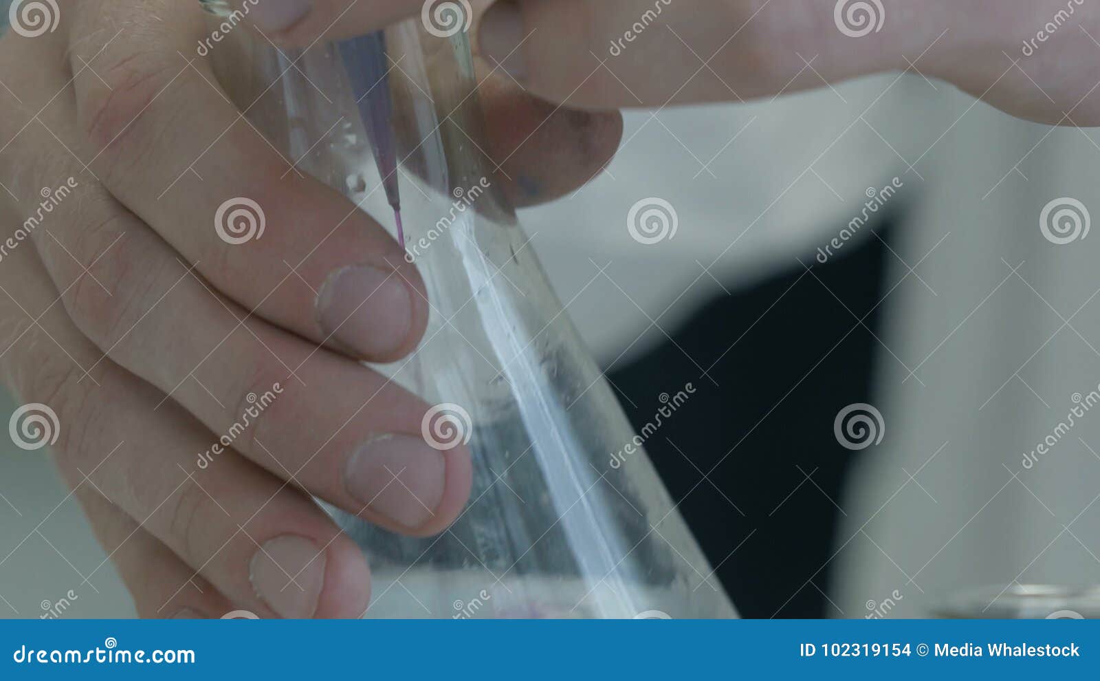 Hand Pouring Liquid Chemicals into Flask. Lab Worker Mixing Chemicals ...