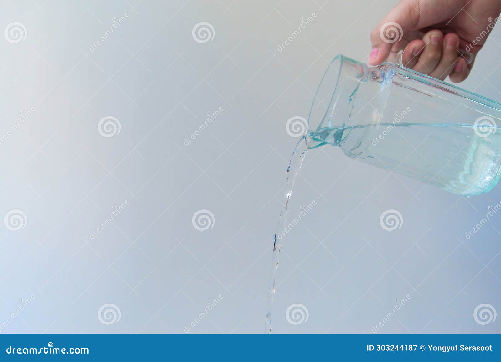 The Hand is Pouring Out of Jug Stock Image - Image of hand, hold: 303244187