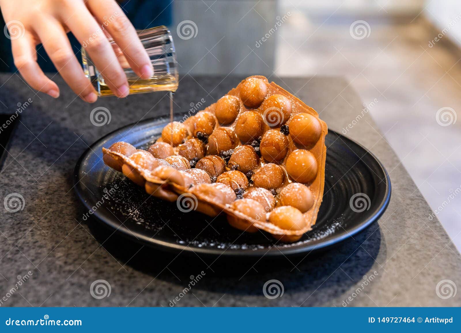 Hand Pouring Syrup on Hong Kong Waffle: a Spherical Egg-based Waffle ...