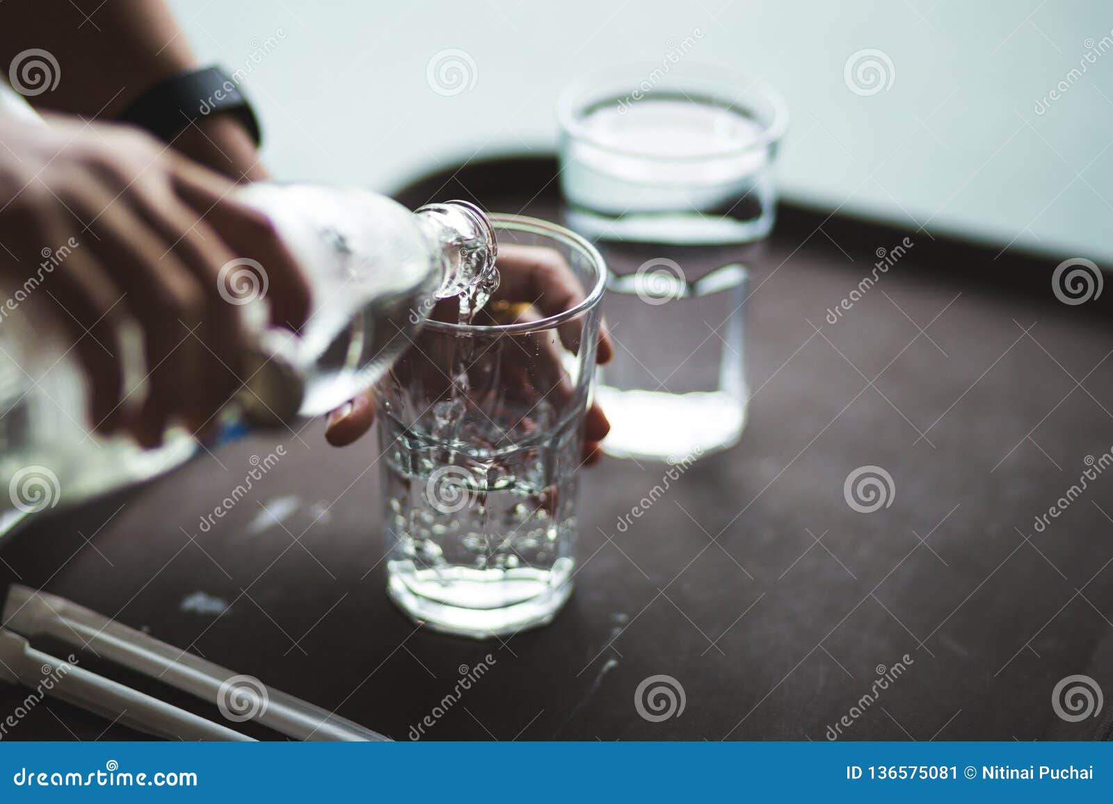 Hand Pouring Water into a Glass Bottle Stock Image - Image of cold ...