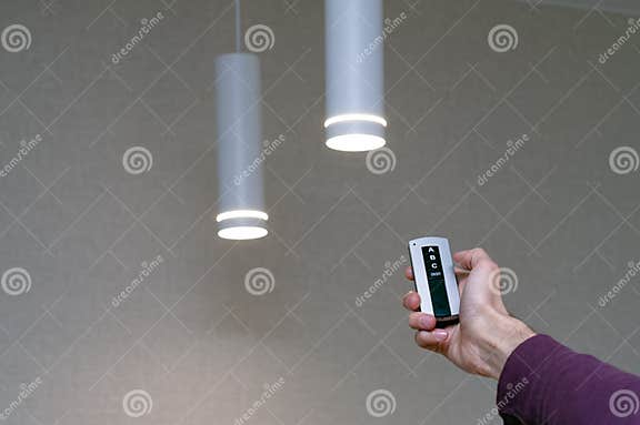 Hand Pressing a Remote Control Controlling an Light Stock Image - Image ...