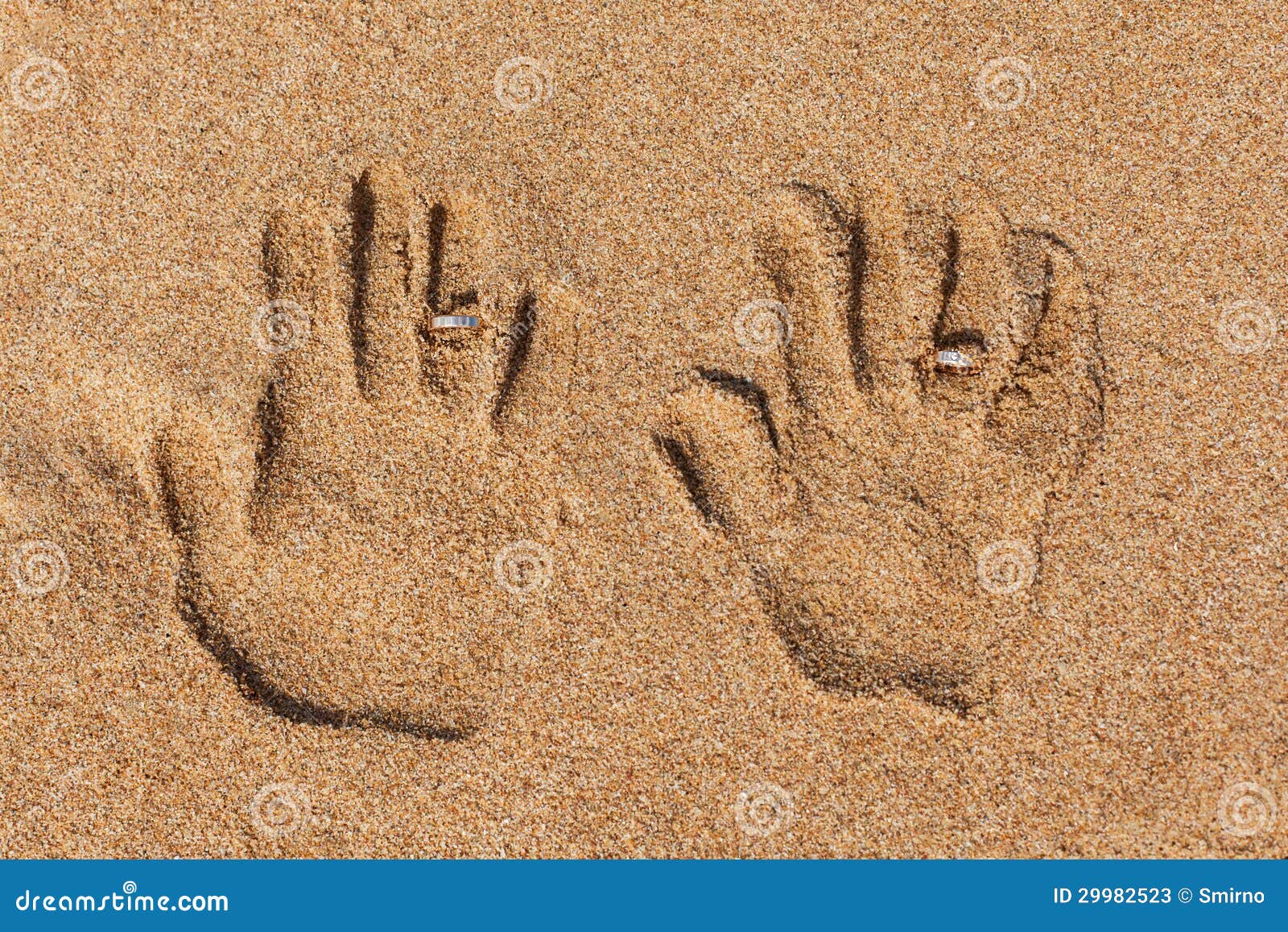 Hand prints on the sand. stock image. Image of yellow - 29982523