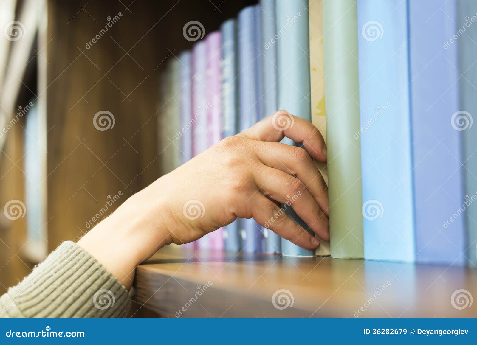 Hand Pulling a Book Off the Shelf Stock Image - Image of hands ...