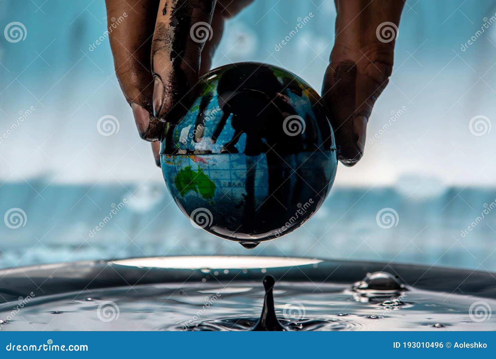 Hand is Pulling the Earth in the Form of a Globe Out of the Oil ...