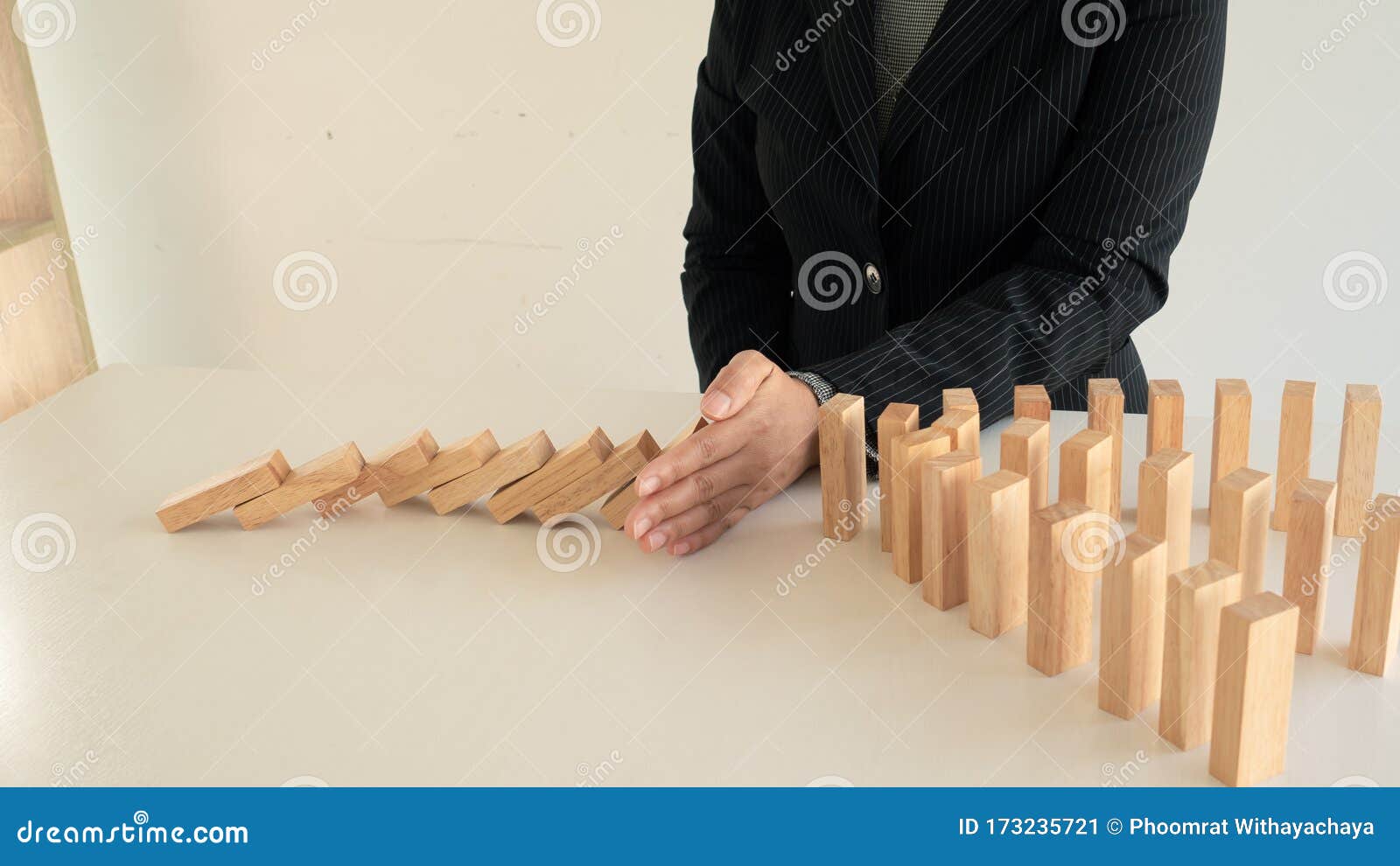 Hand Stopping Falling Wooden Blocks or Dominoes. Business, Risk ...